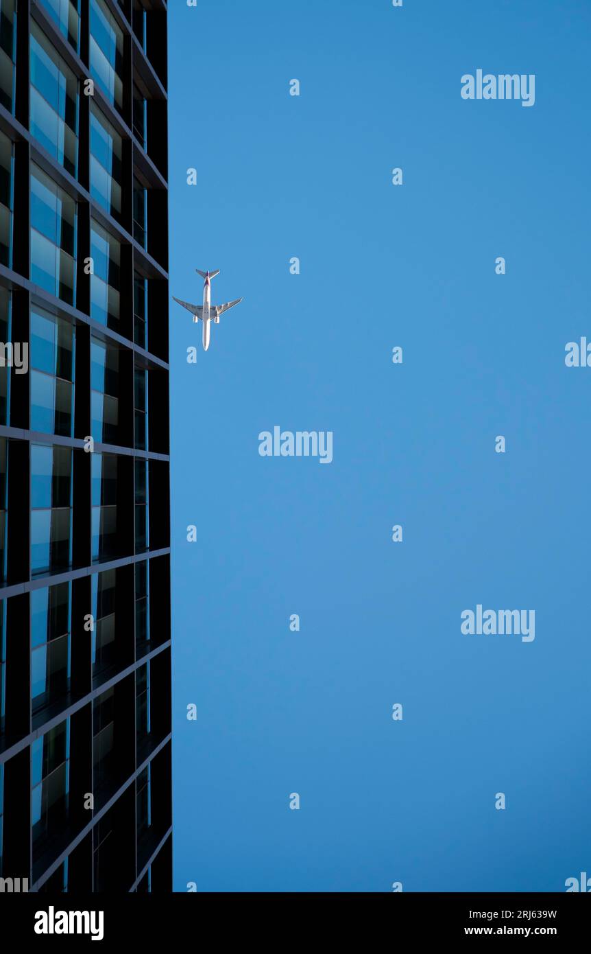 An airplane flying over a bustling city skyline, with tall skyscrapers ...