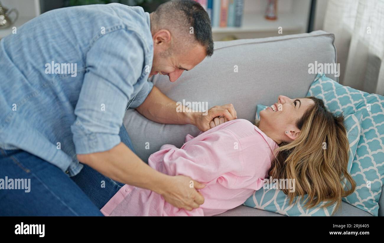 Man and woman couple laughing a lot for tickles at home Stock Photo - Alamy