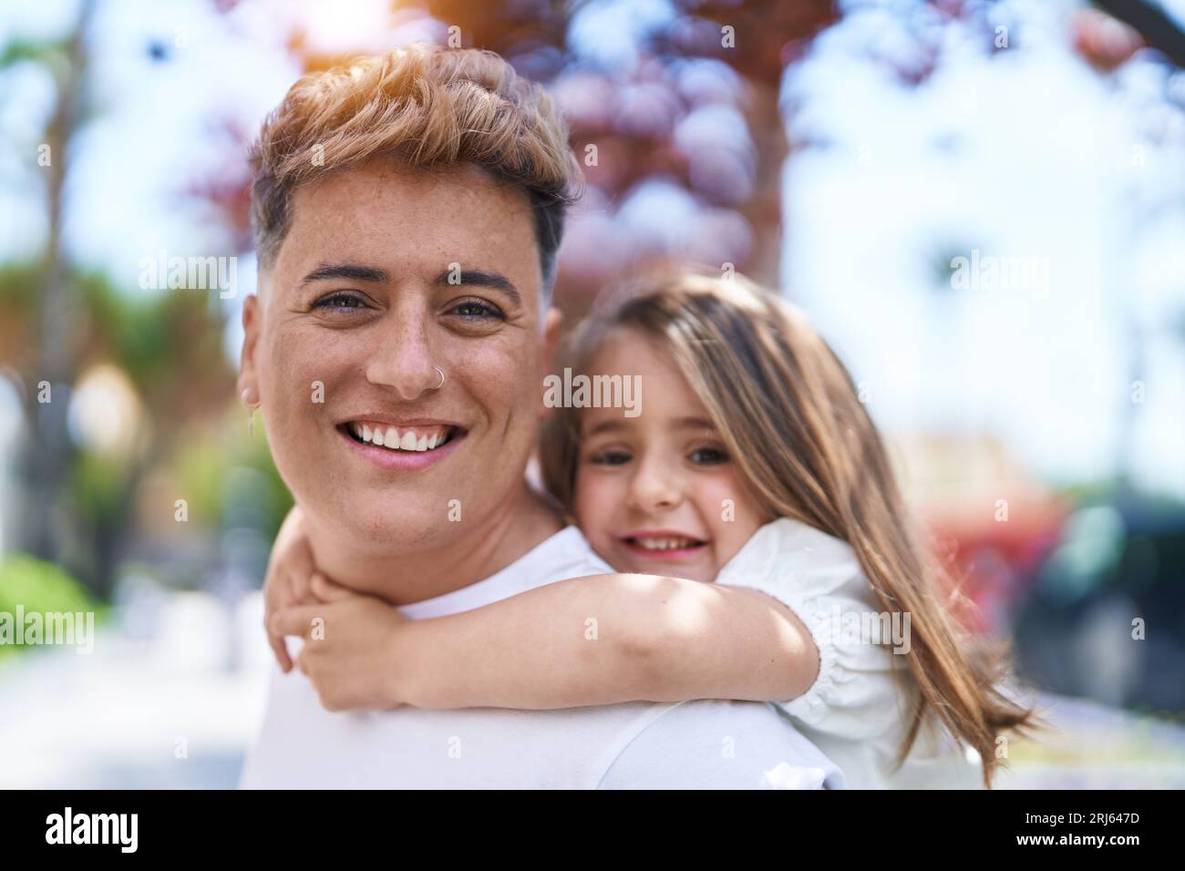 Father and daughter smiling confident hugging each other holding on back at park Stock Photo - Alamy