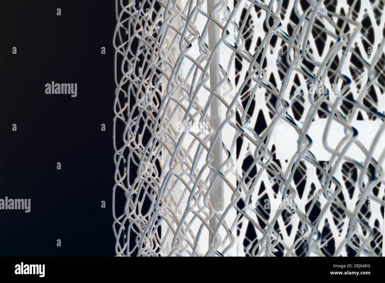 Industrial metal chain link fence with a typical repeating pattern in a ...