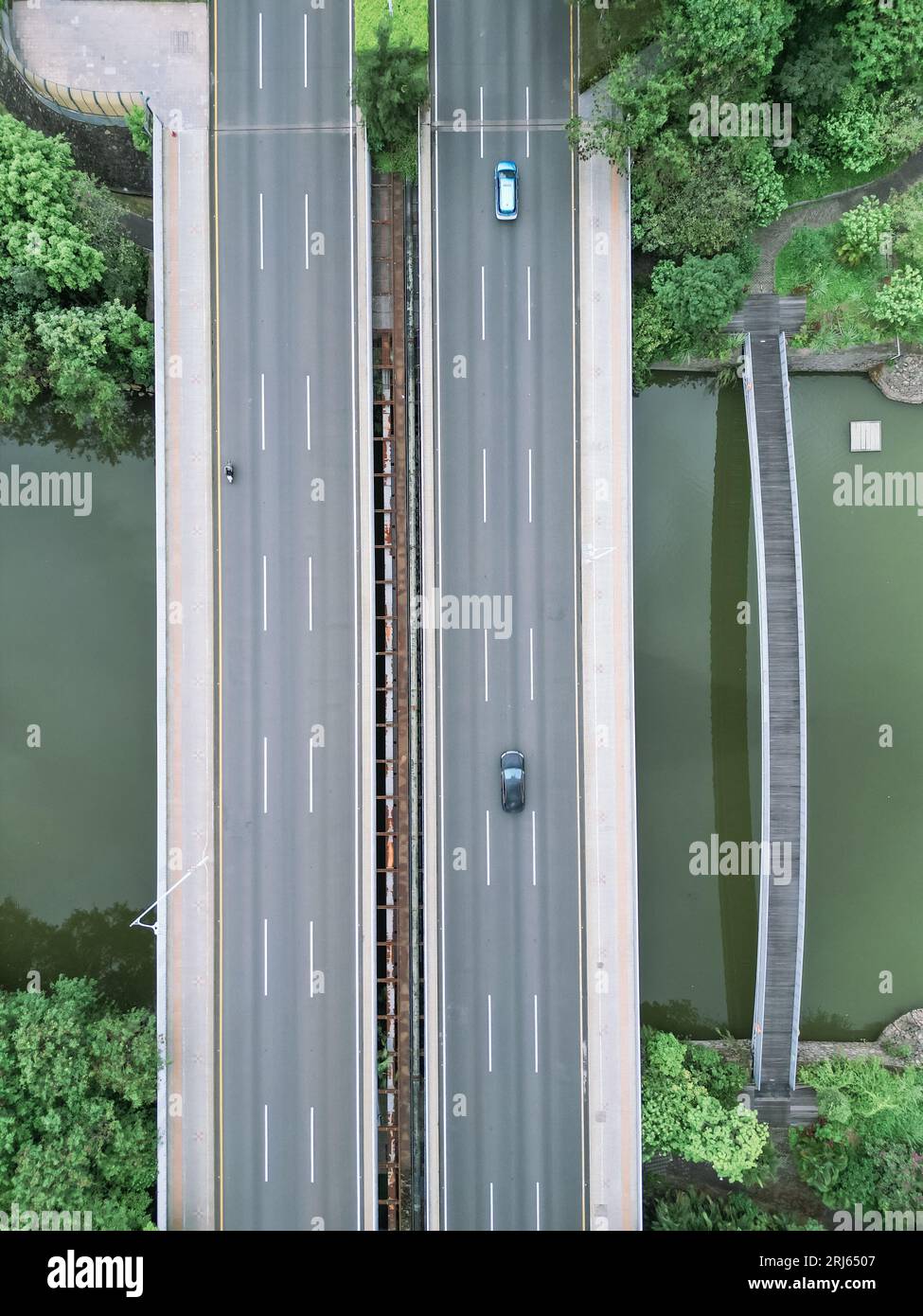 An aerial view of vehicles driving along a stretch of highway in ...