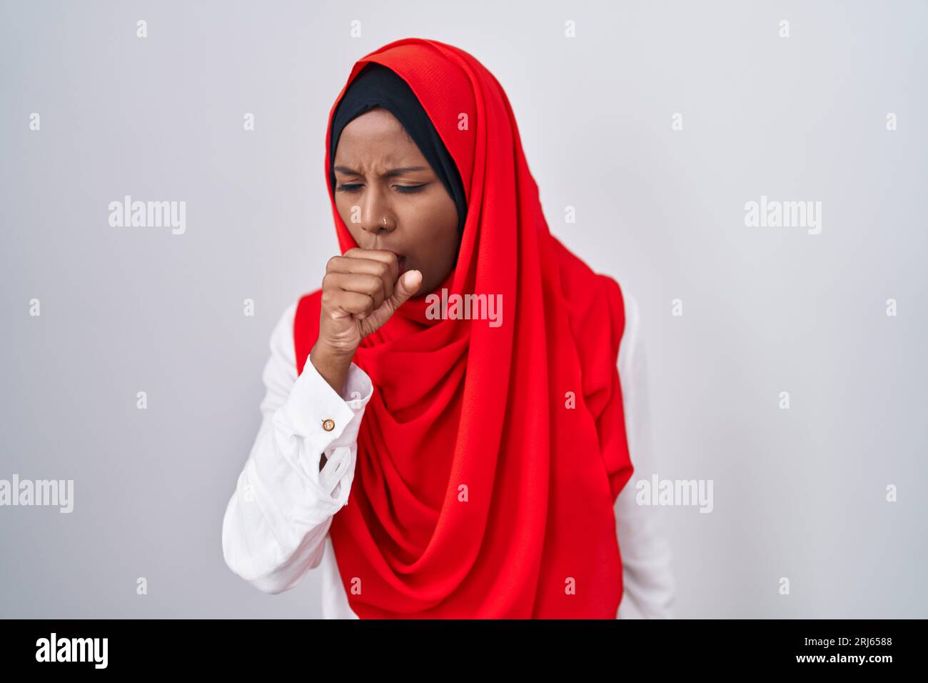 Young arab woman wearing traditional islamic hijab scarf feeling unwell ...