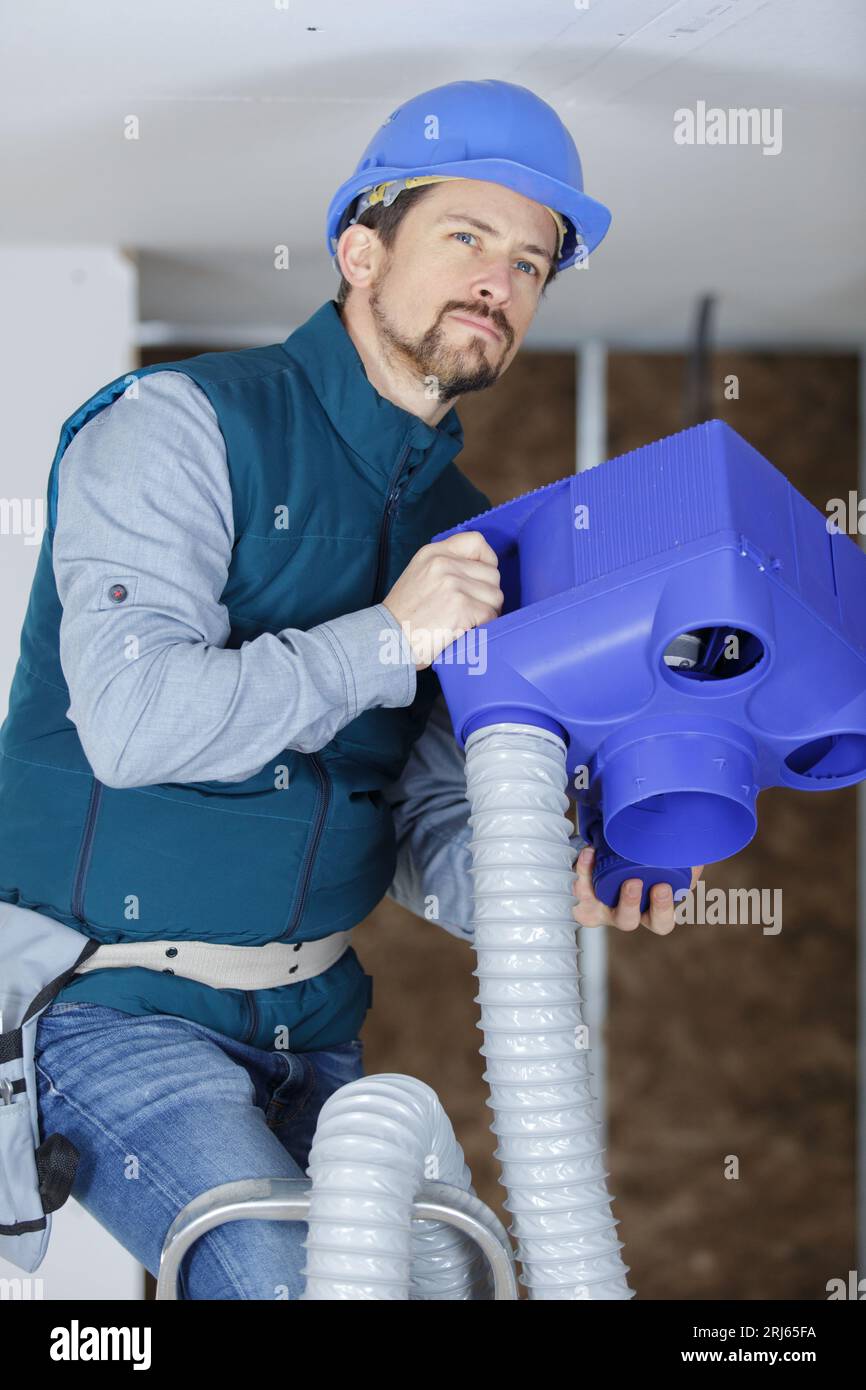man is holding ducting pipes Stock Photo - Alamy