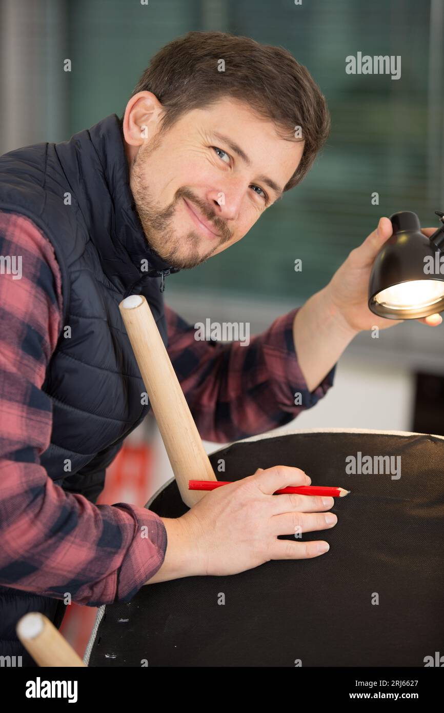 happy man using tools to fix a chair Stock Photo - Alamy