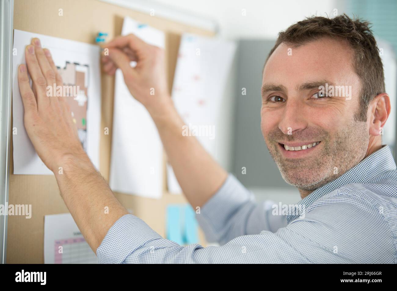 male office worker writing on whiteboard for work schedule Stock Photo ...