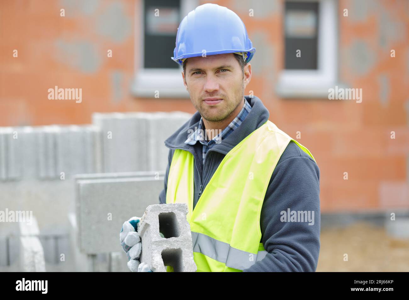 male builder installing concrete blocks Stock Photo - Alamy