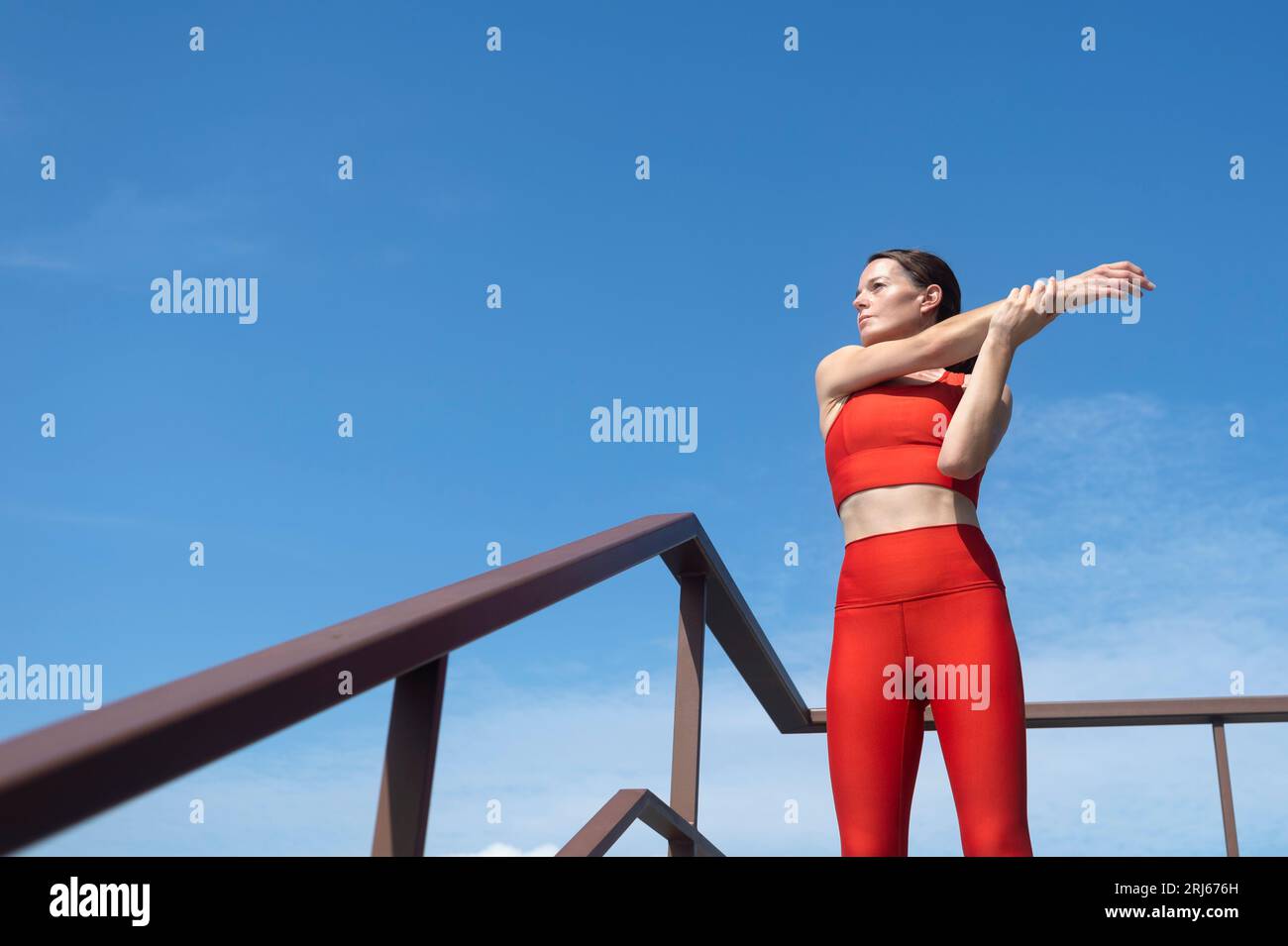 Fit, sporty woman doing an arm stretch outside, Outdoor fitness concept ...