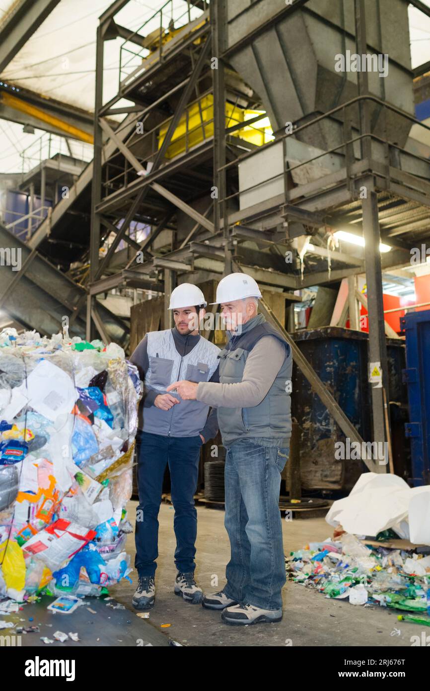 recycling workers checking bottles in recycling plant Stock Photo - Alamy