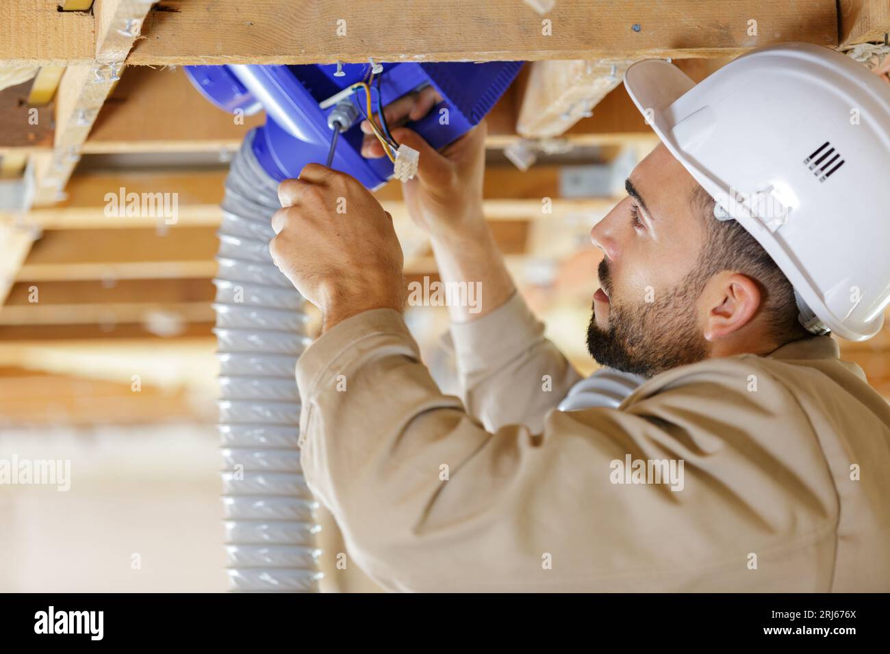 Worker fixing ventilation pipes hi-res stock photography and images - Alamy