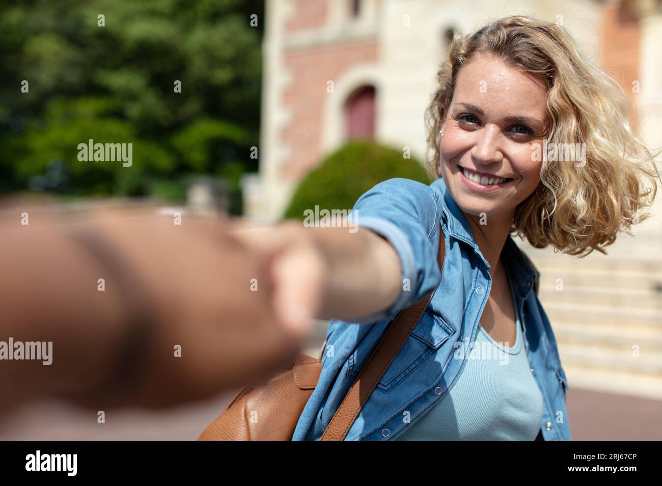 lady pulling friend to visit architectural building Stock Photo - Alamy