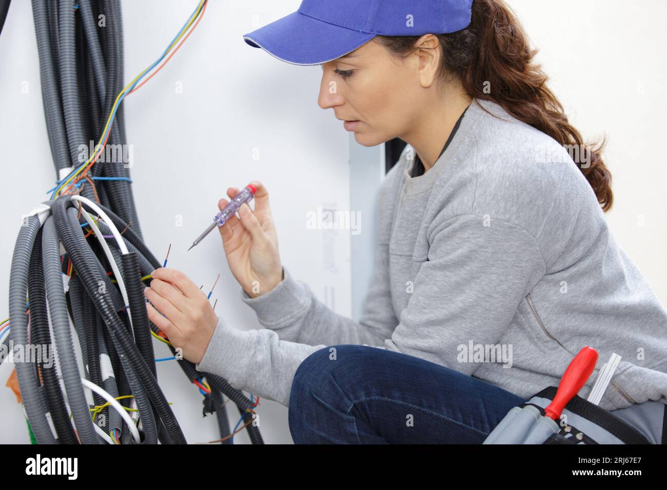Female student connecting wire hi-res stock photography and images - Alamy