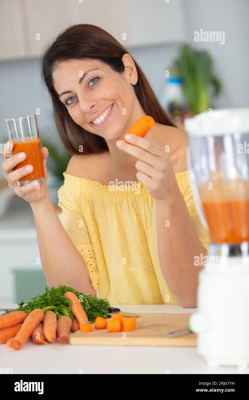attractive woman making smoothie in blender in modern kitchen Stock ...