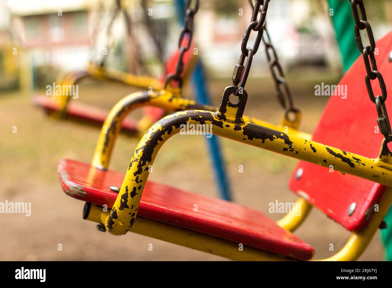 Empty chain swing in playground Stock Photo - Alamy