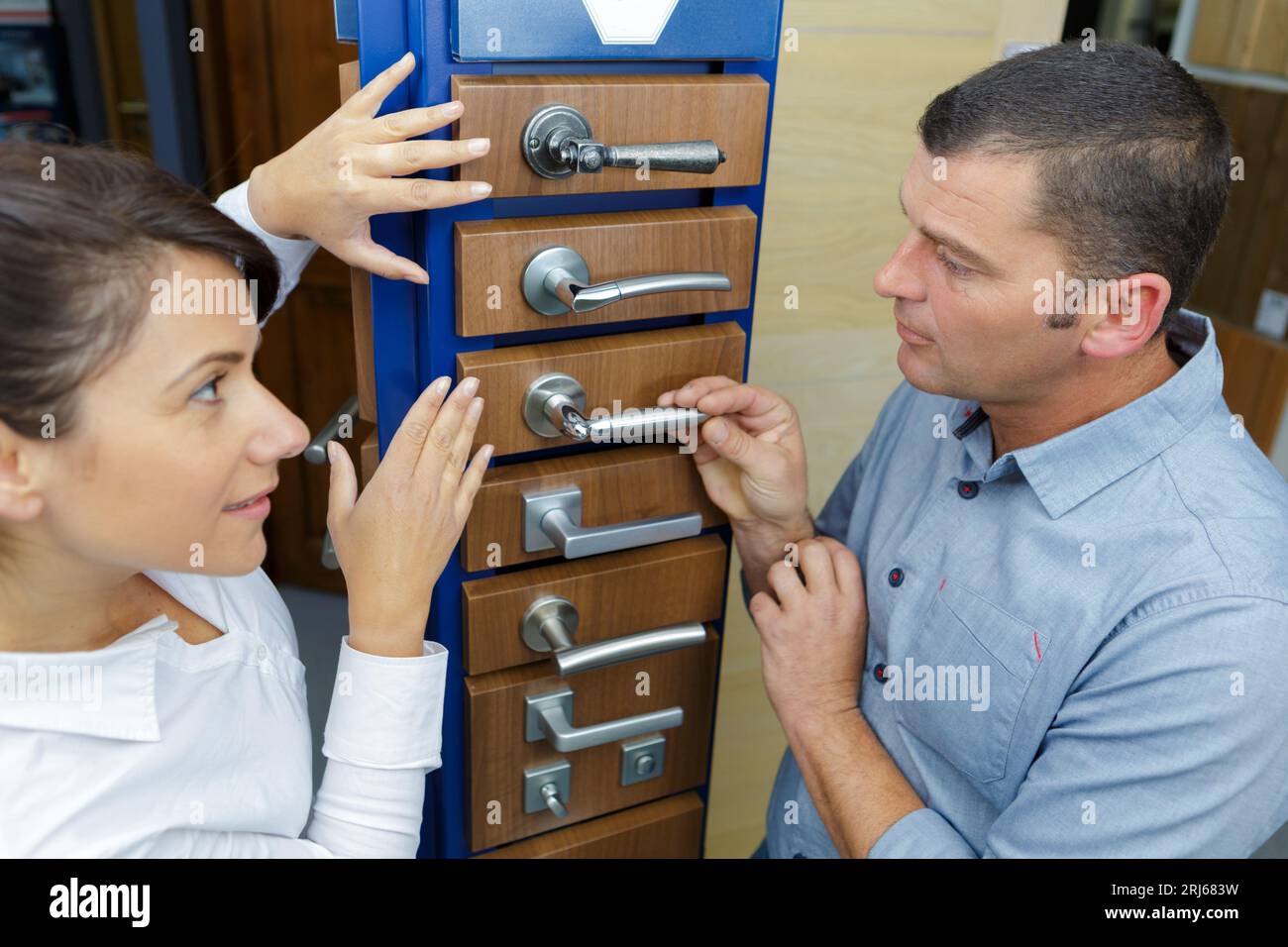 female worker and showcase of door handles Stock Photo - Alamy