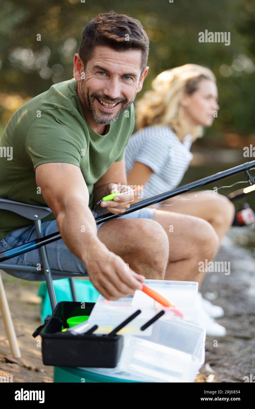 couple sitting and enjoying fishing Stock Photo - Alamy