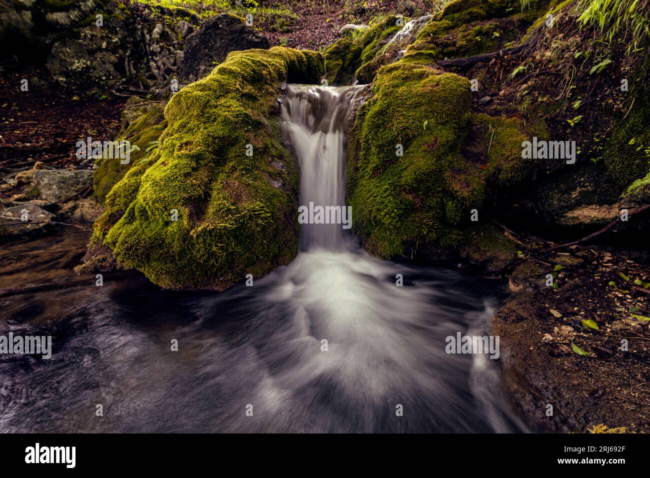 Serene waterfall cascades down rocky hi-res stock photography and ...