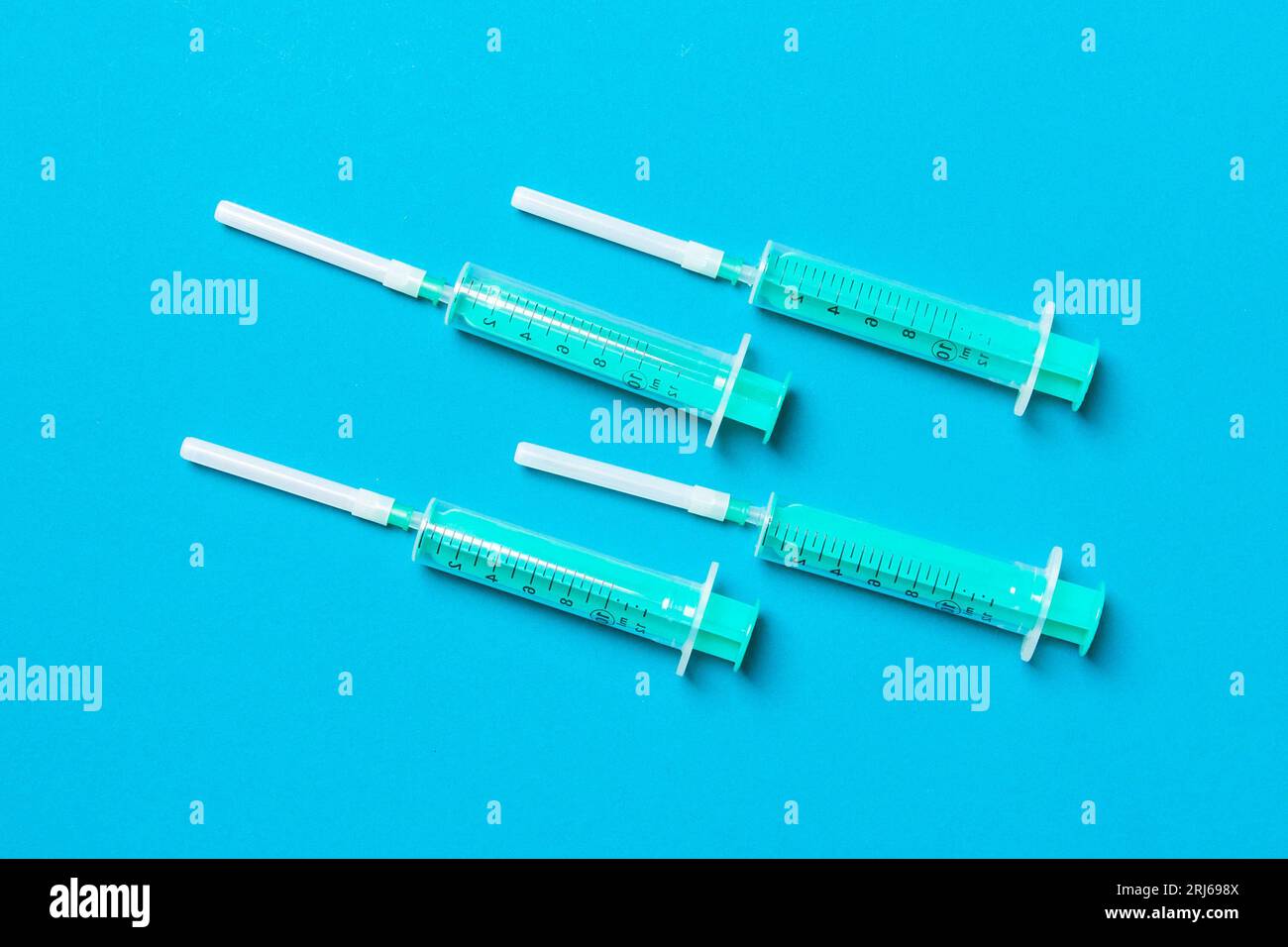 Top view of different syringes for injection on colorful background ...