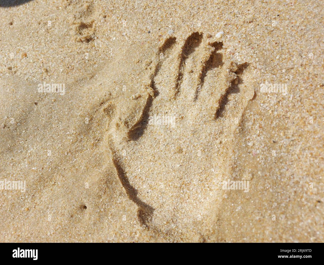 A closeup of a handprint on the sand in the beach Stock Photo - Alamy
