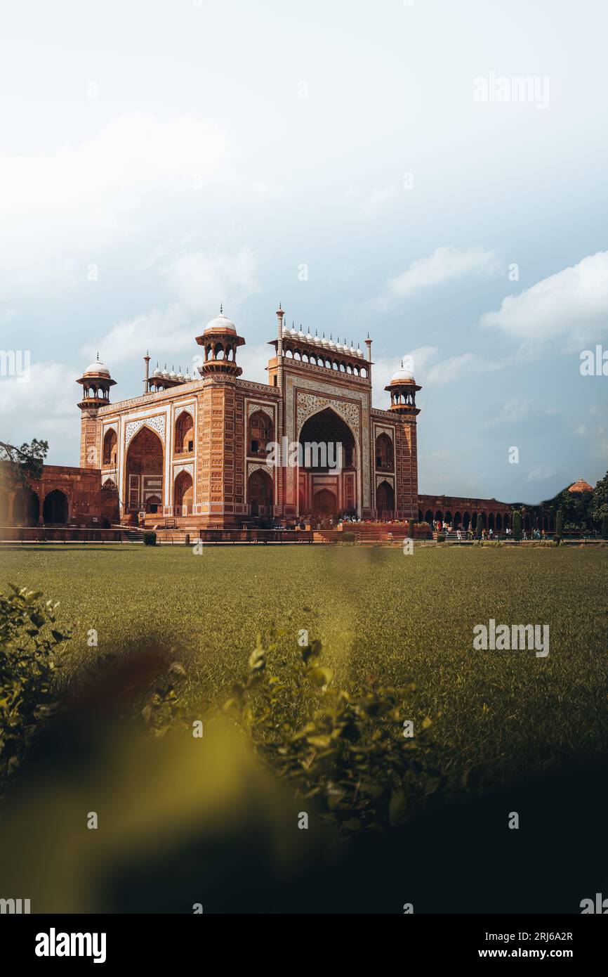An iconic Taj Mahal monument against a cloudy blue sky in India Stock ...