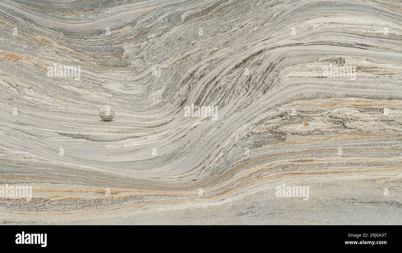 The granite stone waves as background with three round stones Stock ...