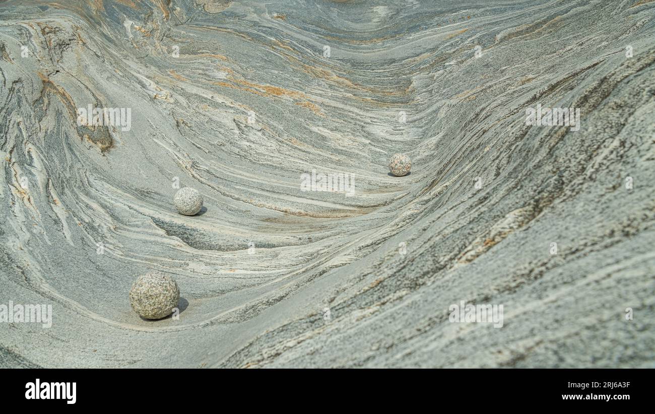 The granite stone waves as background with three round stones Stock ...