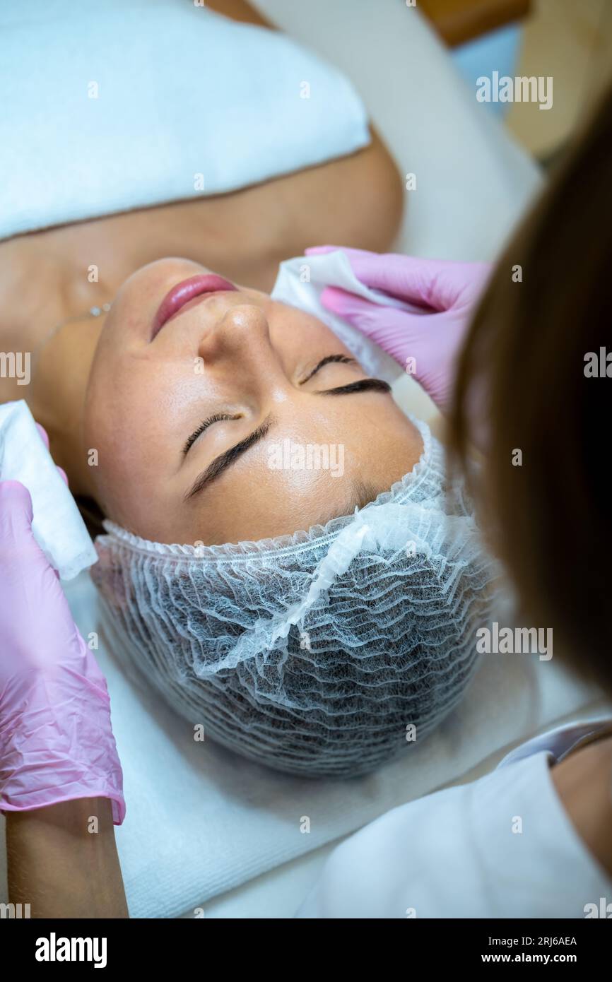 Cosmetologist doing beauty procedures or treatment to woman client in ...