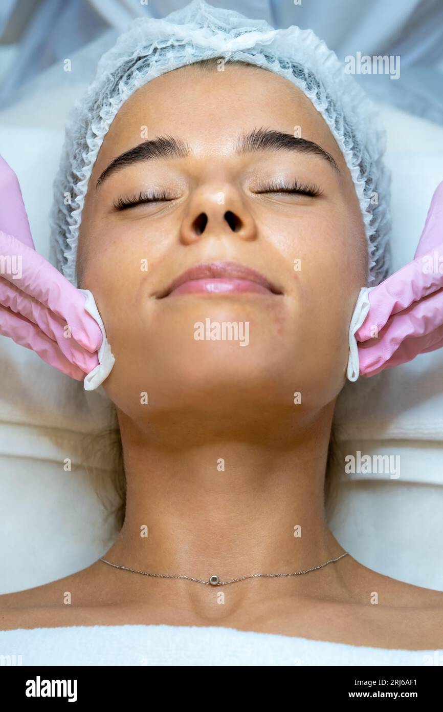 Cosmetologist doing beauty procedures or treatment to woman client in ...