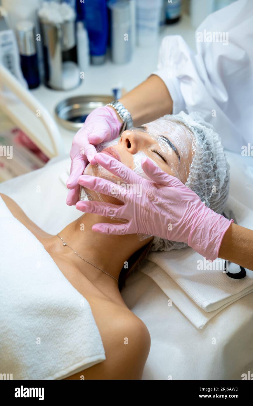 Cure of face skin in cosmetology clinic. Beauty procedure for young ...