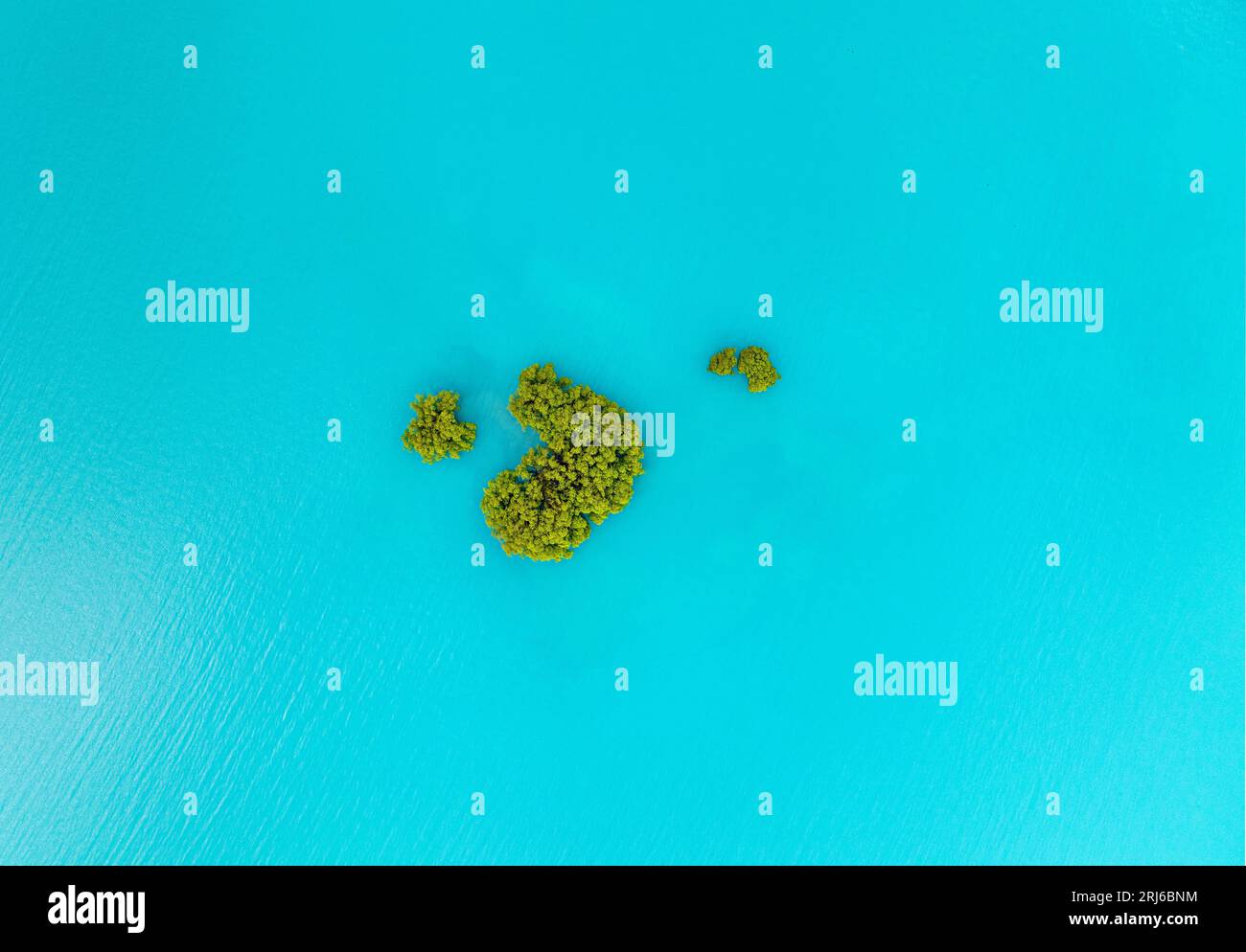 An aerial view of a small green island in a blue lake Stock Photo - Alamy