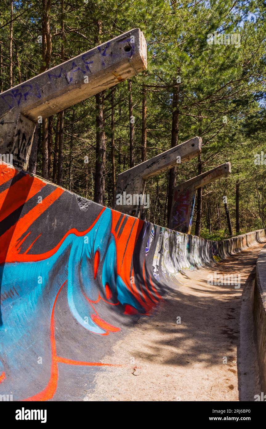 a mini skateboard ramp fully covered with graffiti in the middle of a ...