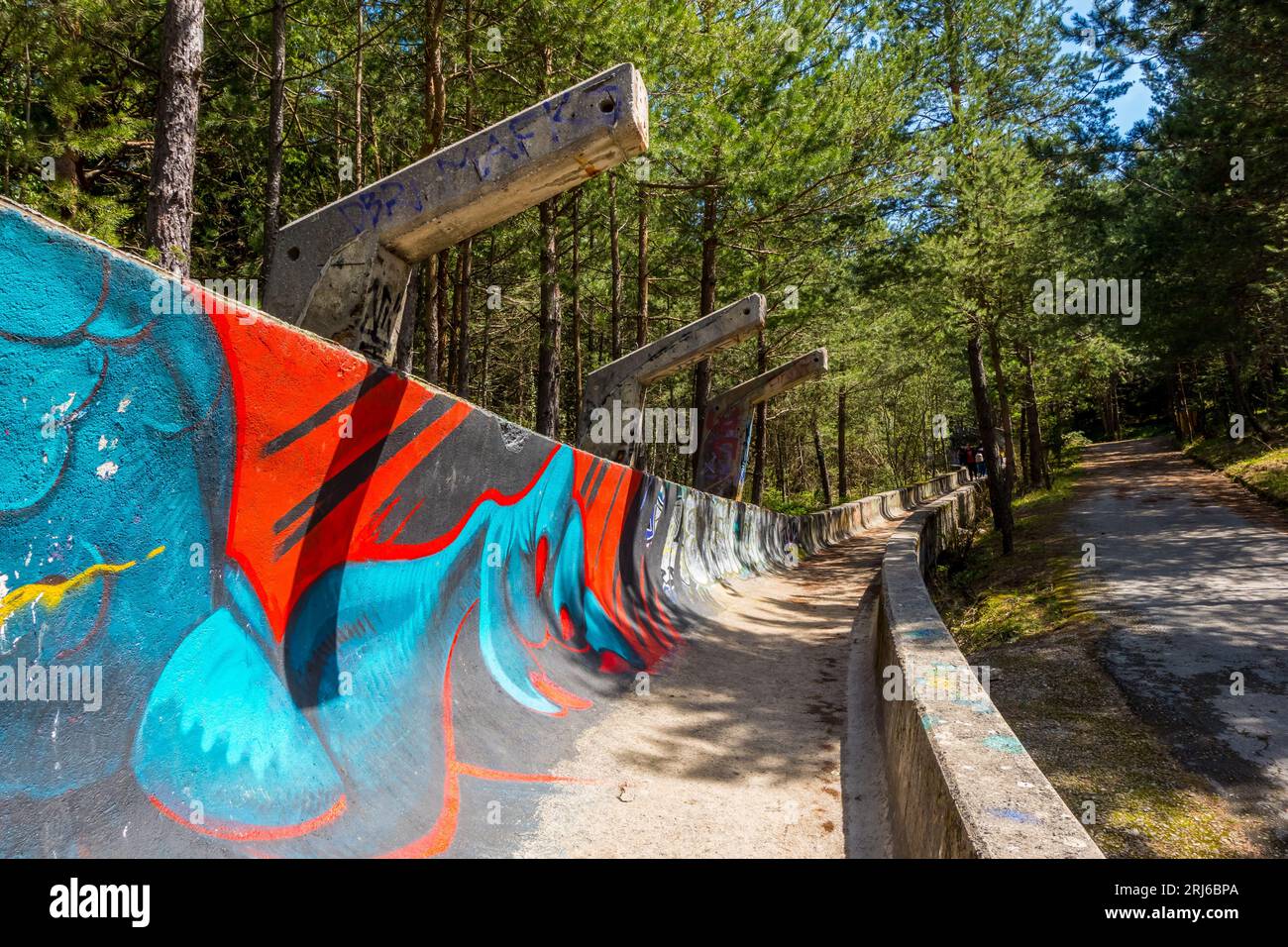 a mini skateboard ramp fully covered with graffiti in the middle of a ...