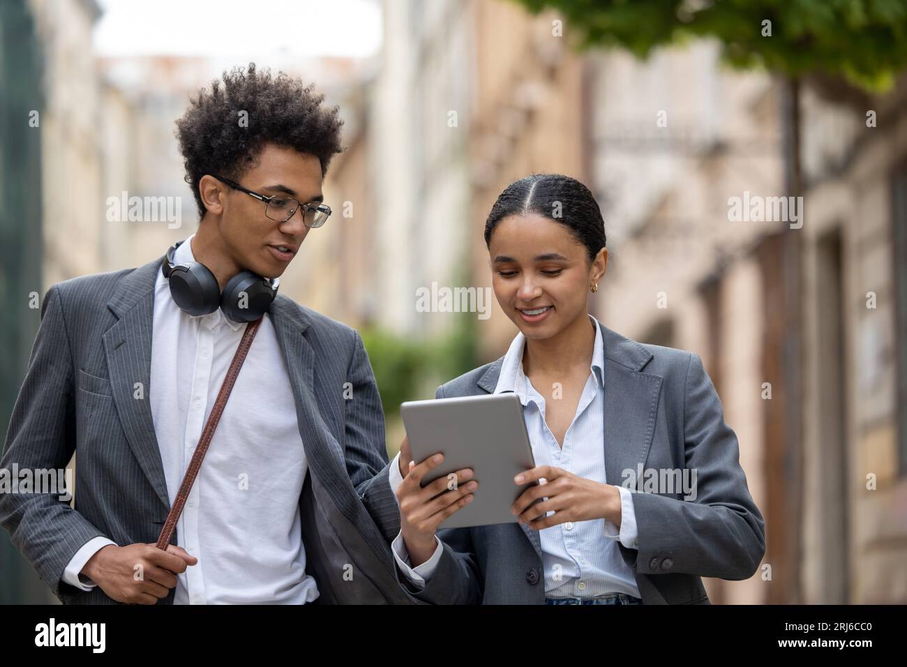 Friends going home after work and discussing something Stock Photo - Alamy