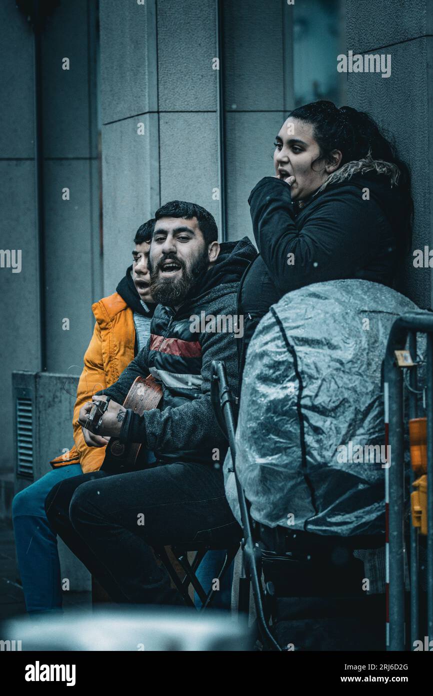 A family singing Christmas songs in the street of Basel, Switzerland ...