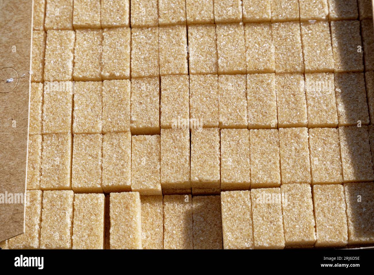 A close-up of a cardboard box filled to the brim with sugar cubes Stock ...