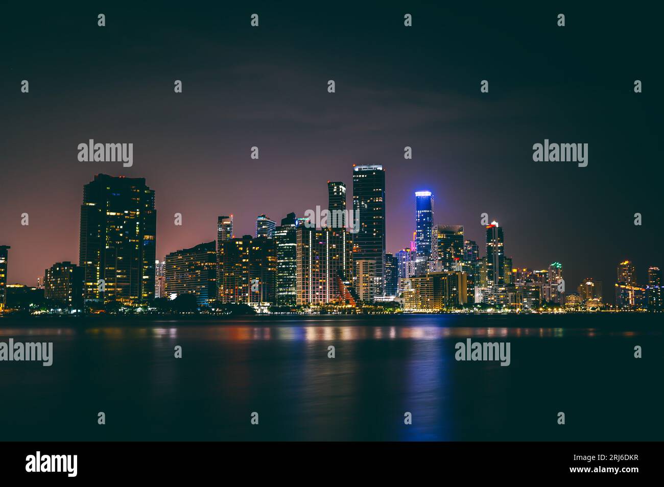A stunning landscape of the illuminated modern city at the waterfront ...