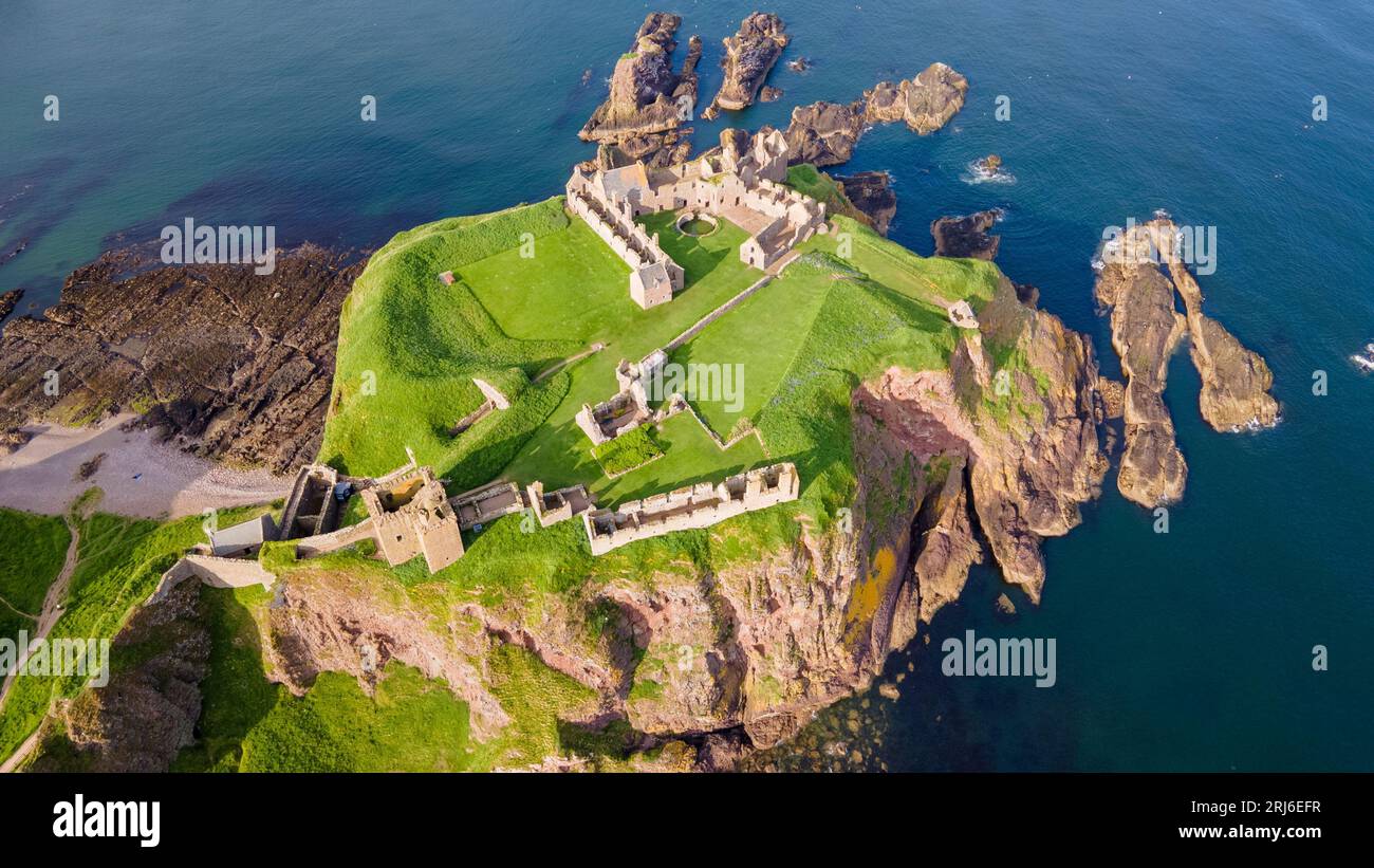Aerial view of a beautiful castle situated by the serene blue ocean ...