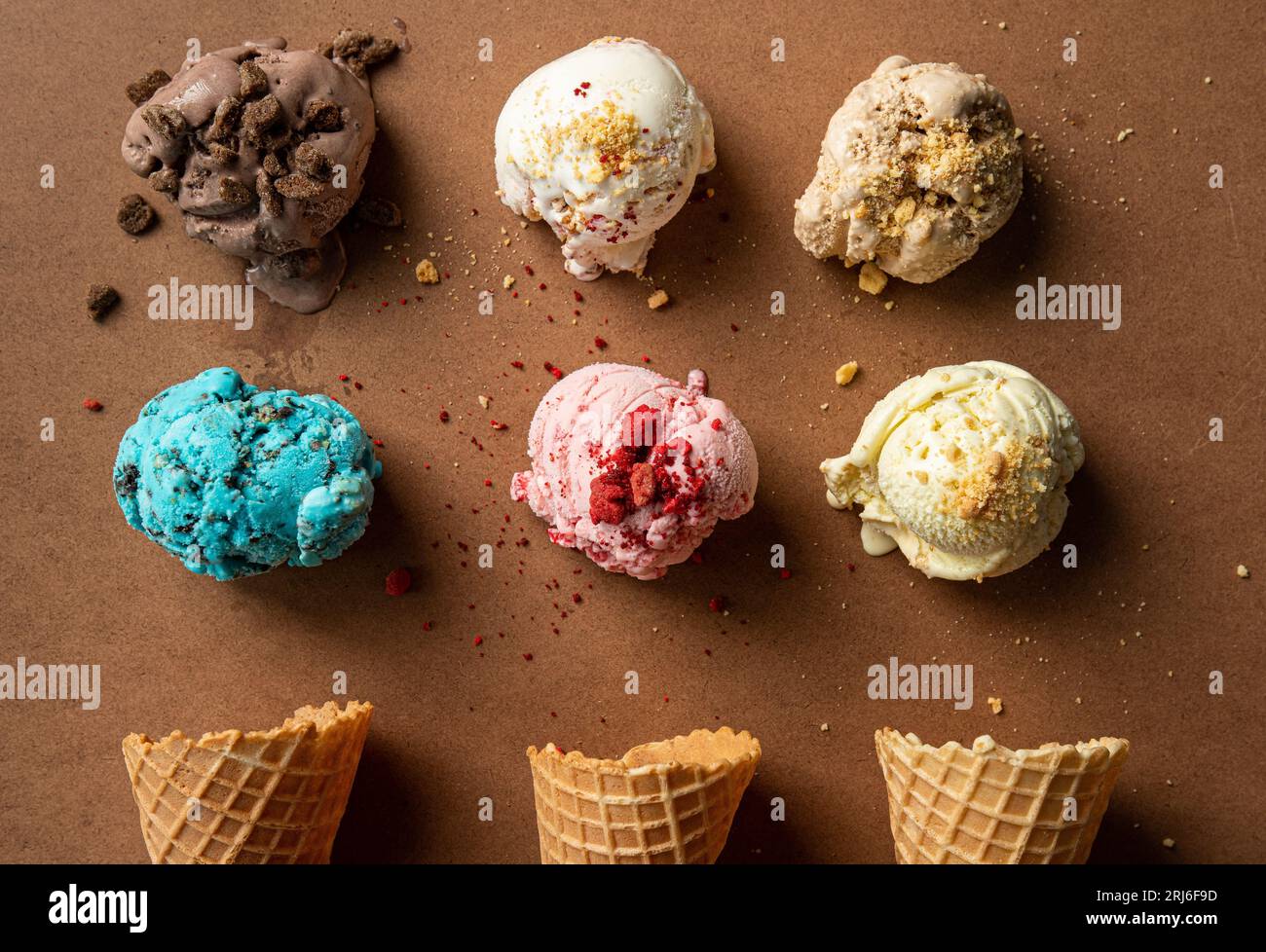 A top view of colorful ice cream scoops with freshly-baked cones ...
