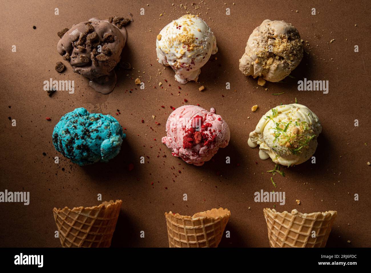 A top view of colorful ice cream scoops with freshly-baked cones ...