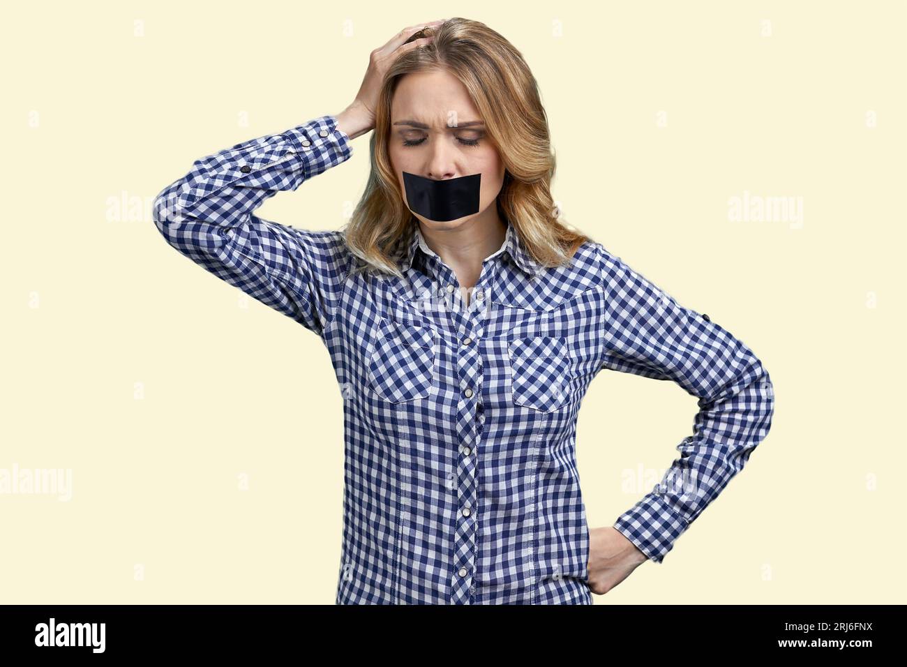 Portrait of young desperate blond woman with her mouth taped. Young ...