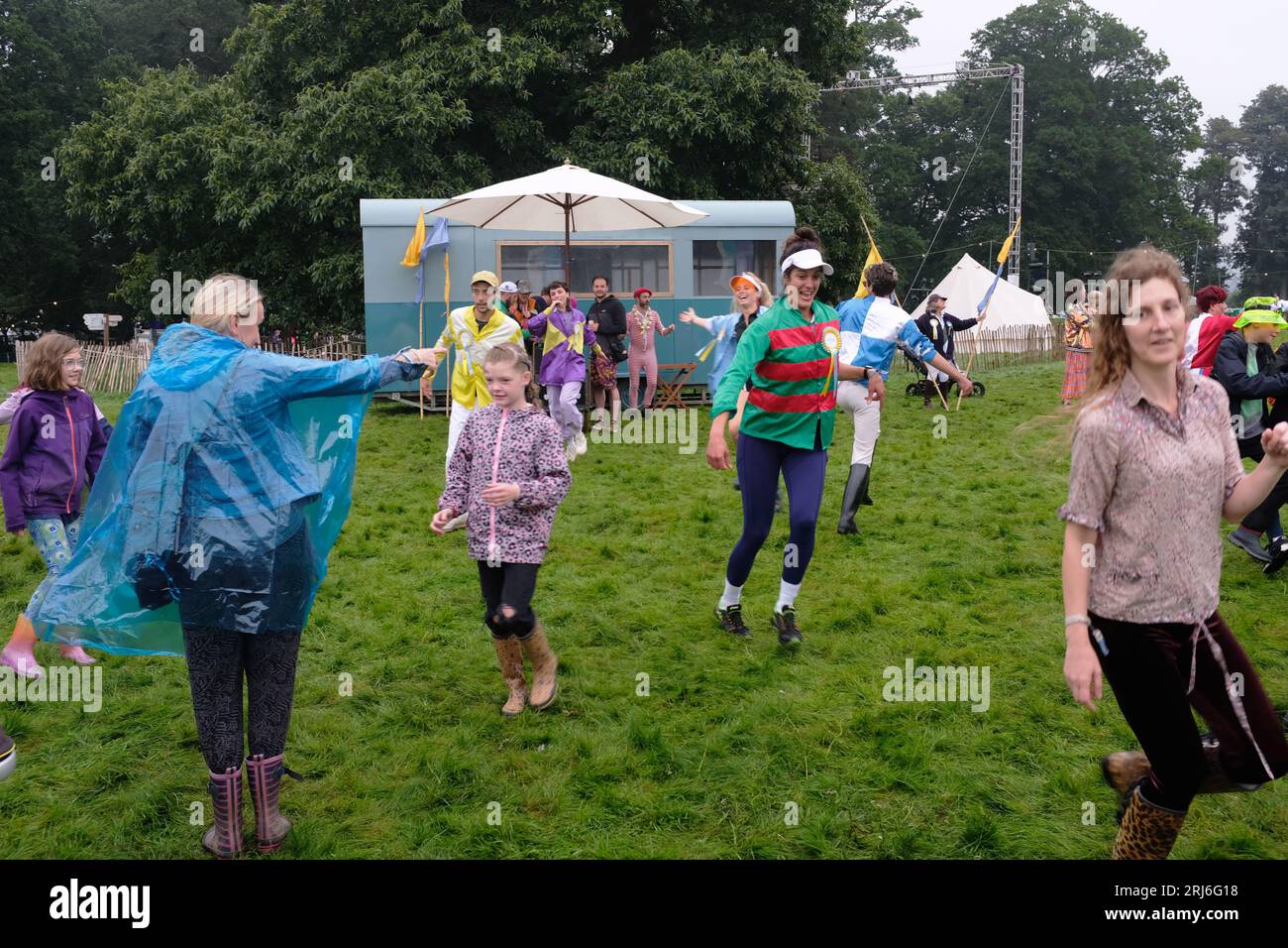 People dancing in the rain at a festival in the UK Stock Photo - Alamy