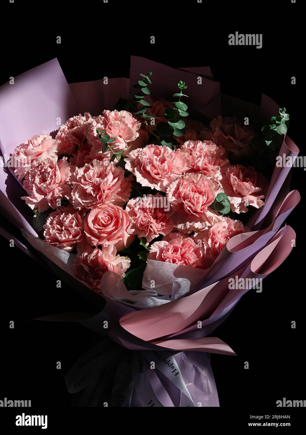 A vibrant bouquet of pink and white carnations and roses arranged ...