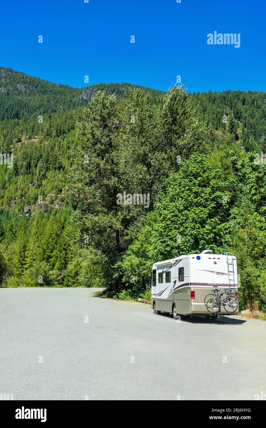 Luxury motorhome with bykes attached to the rack on an asphalt road ...