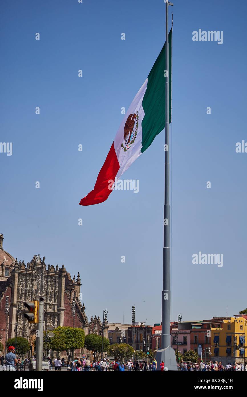 The Mexican flag waving against the backdrop of a blue sky. Zocalo ...
