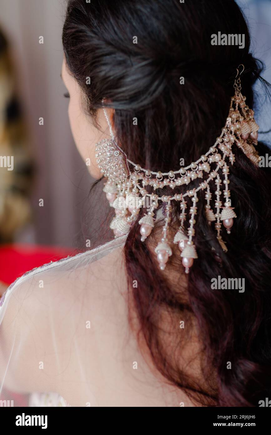 A back view of a woman's head showing her tied up beautiful long hair ...
