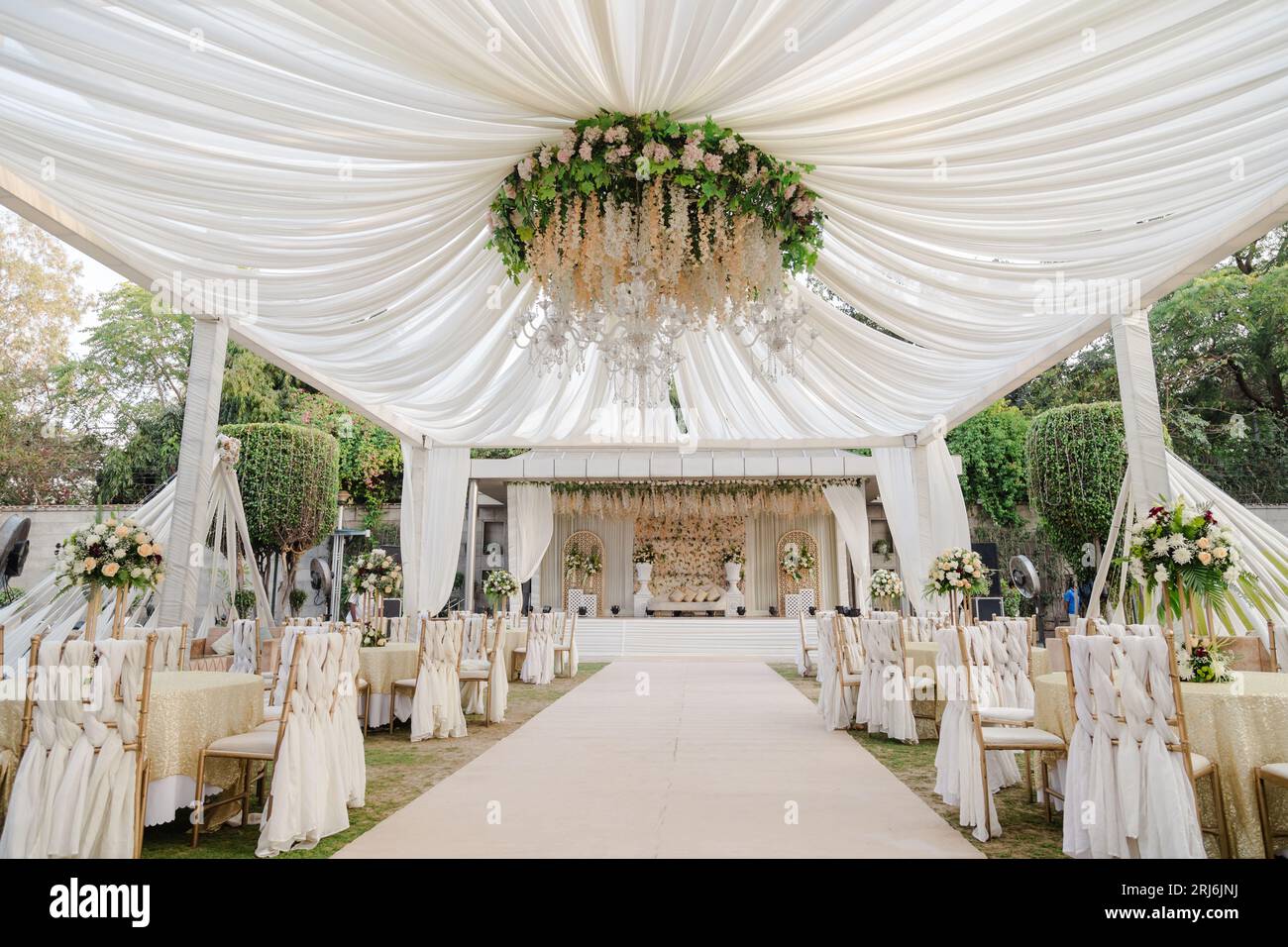 A luxurious white wedding reception featuring elegant floral ...