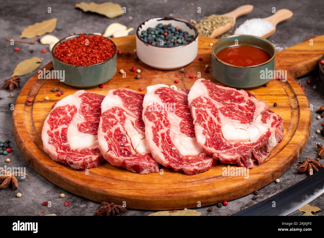 Raw meat ribeye steak entrecote. Raw ribeye on dark background. Butcher ...