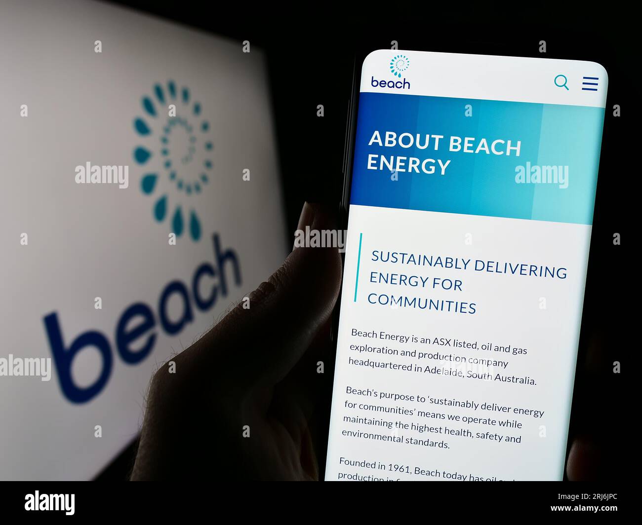 Person holding cellphone with webpage of Australian oil company Beach ...