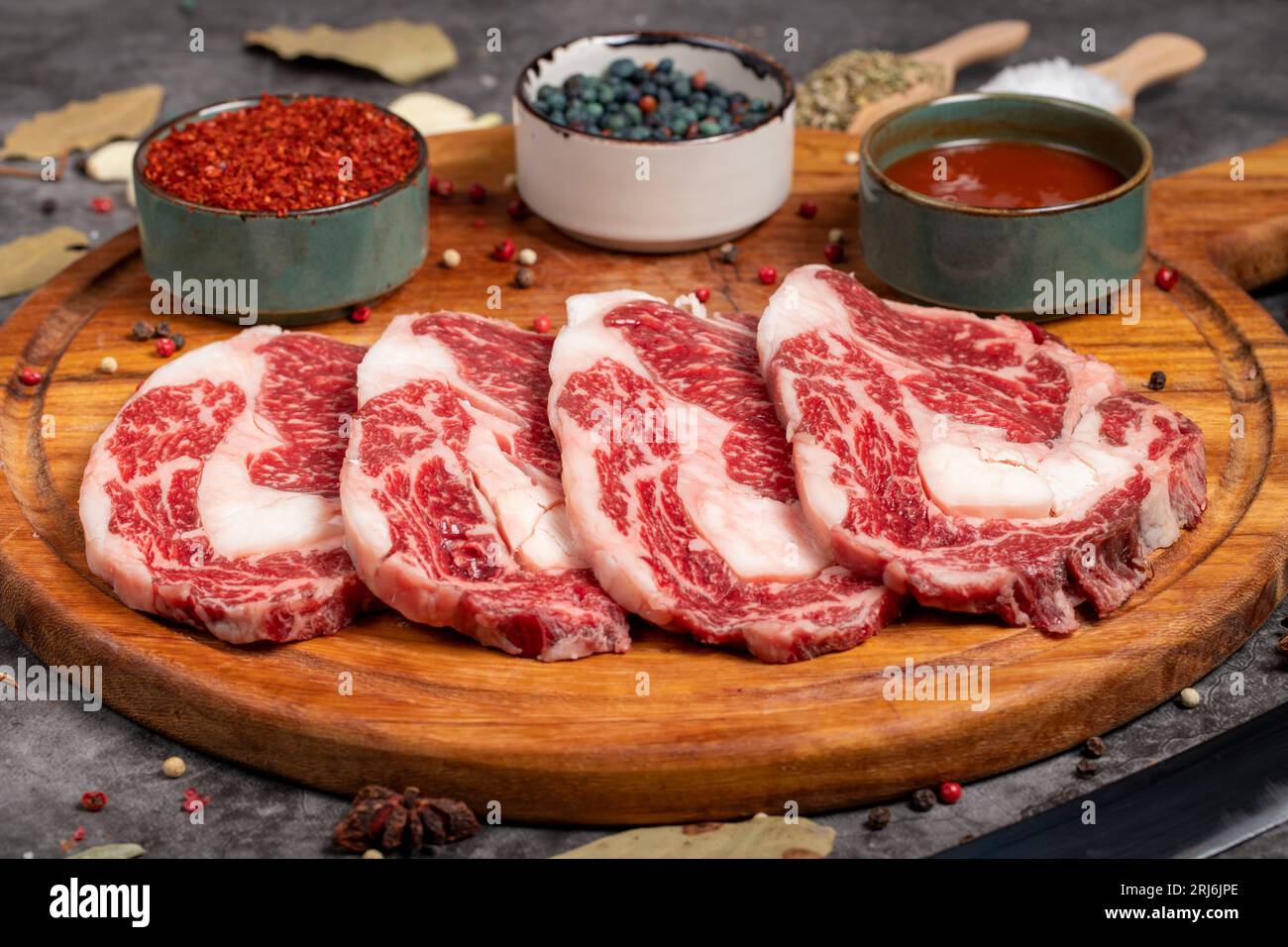 Raw meat ribeye steak entrecote. Raw ribeye on dark background. Butcher ...