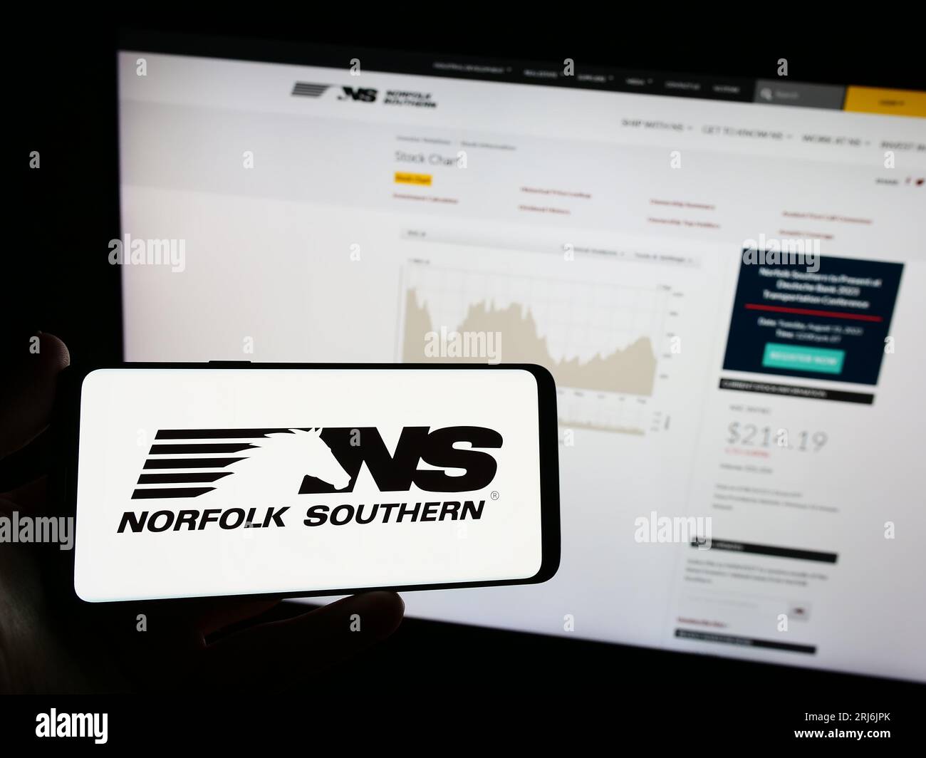 Person holding mobile phone with logo of American railway company ...