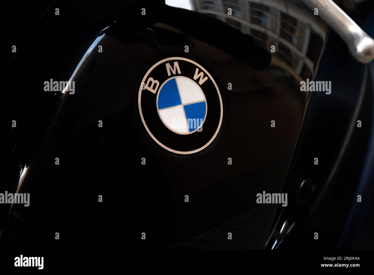 A glossy BMW emblem is displayed prominently on the front of a sleek ...
